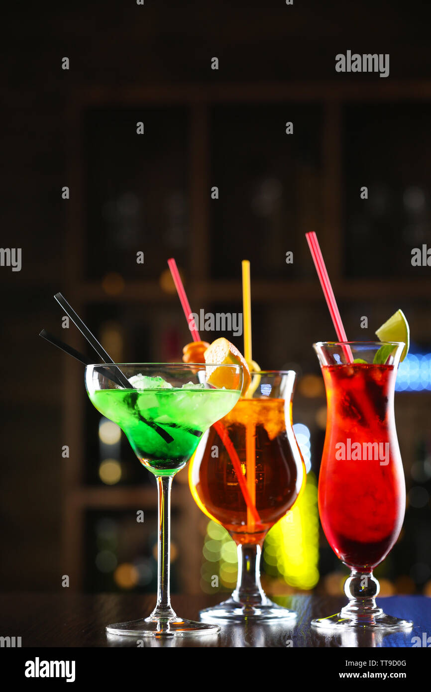 Glasses of cocktails on bar background Stock Photo - Alamy