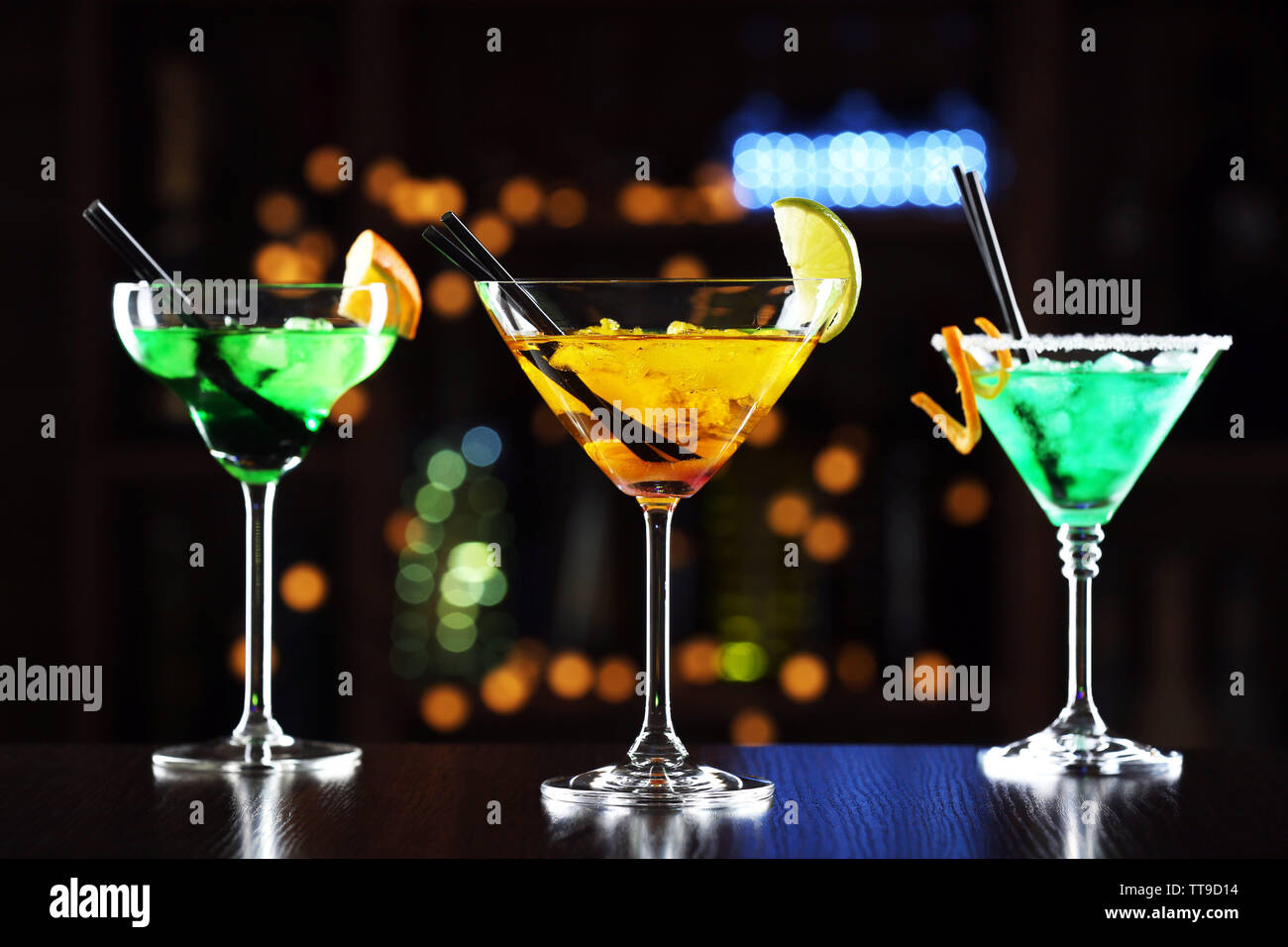 Glasses of cocktails on bar background Stock Photo - Alamy