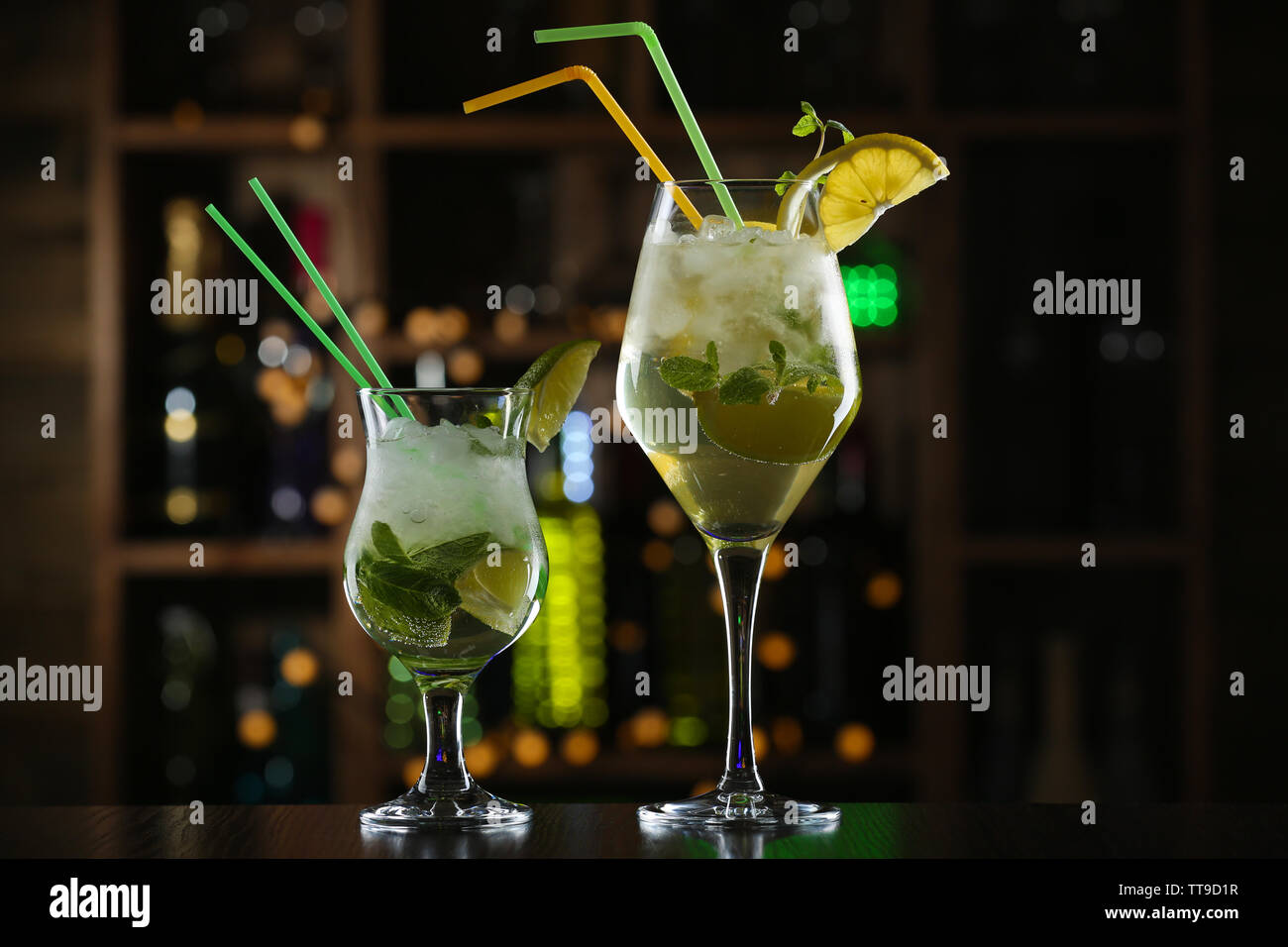 Glasses of cocktails on bar background Stock Photo - Alamy