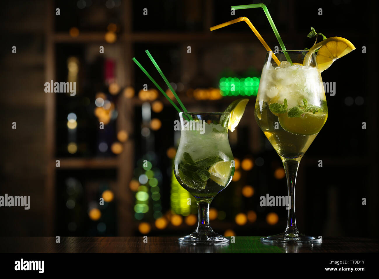 Glasses of cocktails on bar background Stock Photo - Alamy