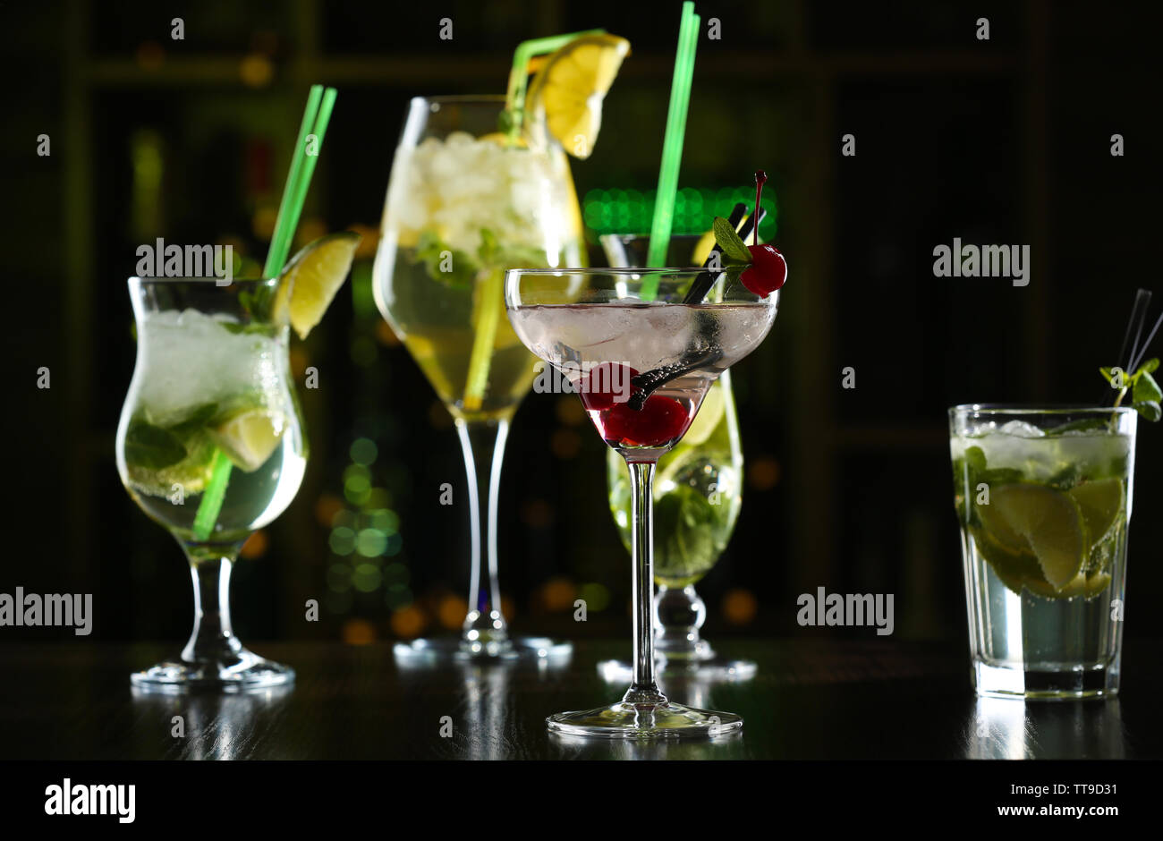 Glasses of cocktails on bar background Stock Photo - Alamy