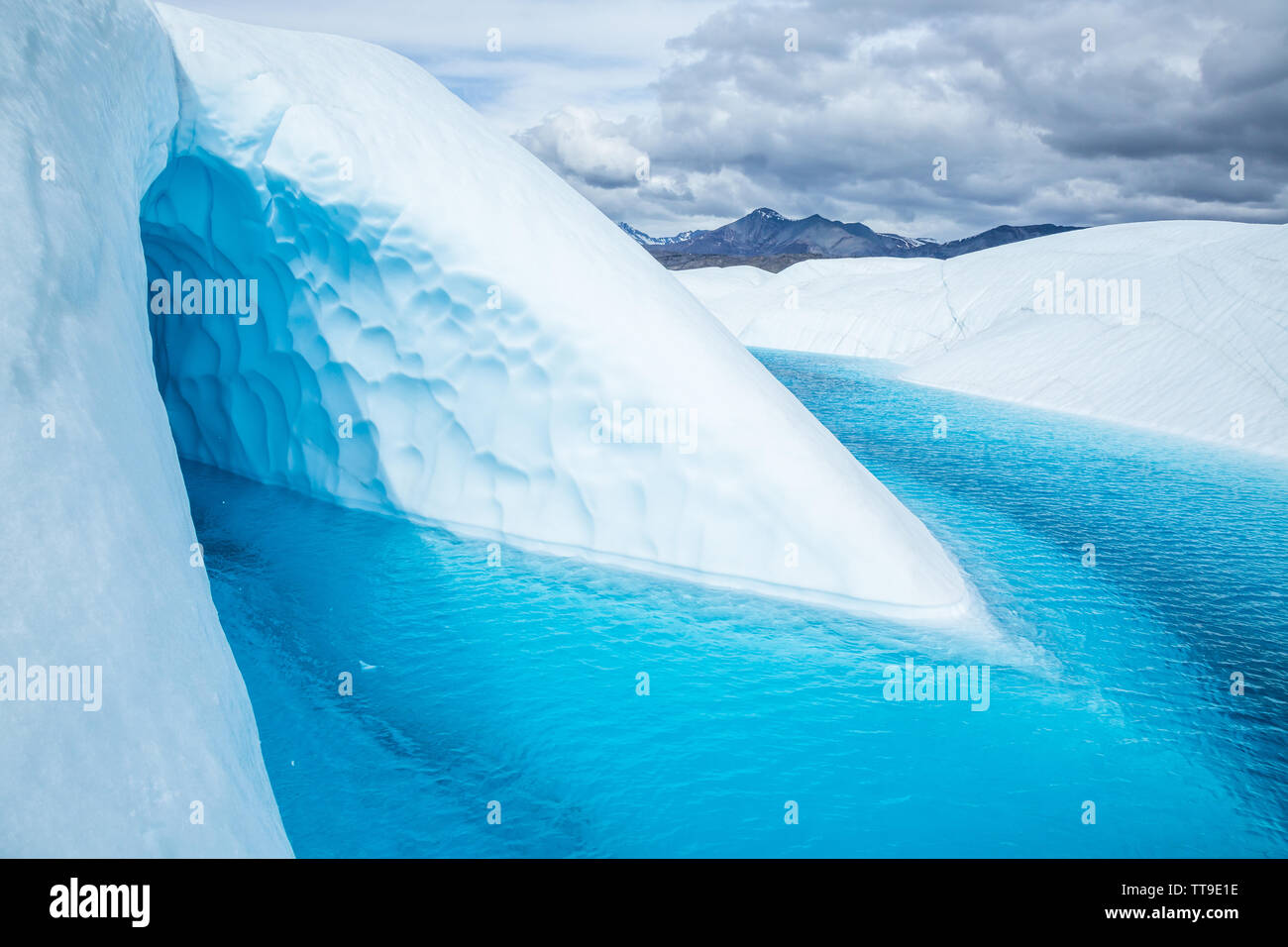 Former ice cave flooded by melting ice as a large blue lake forms on ...