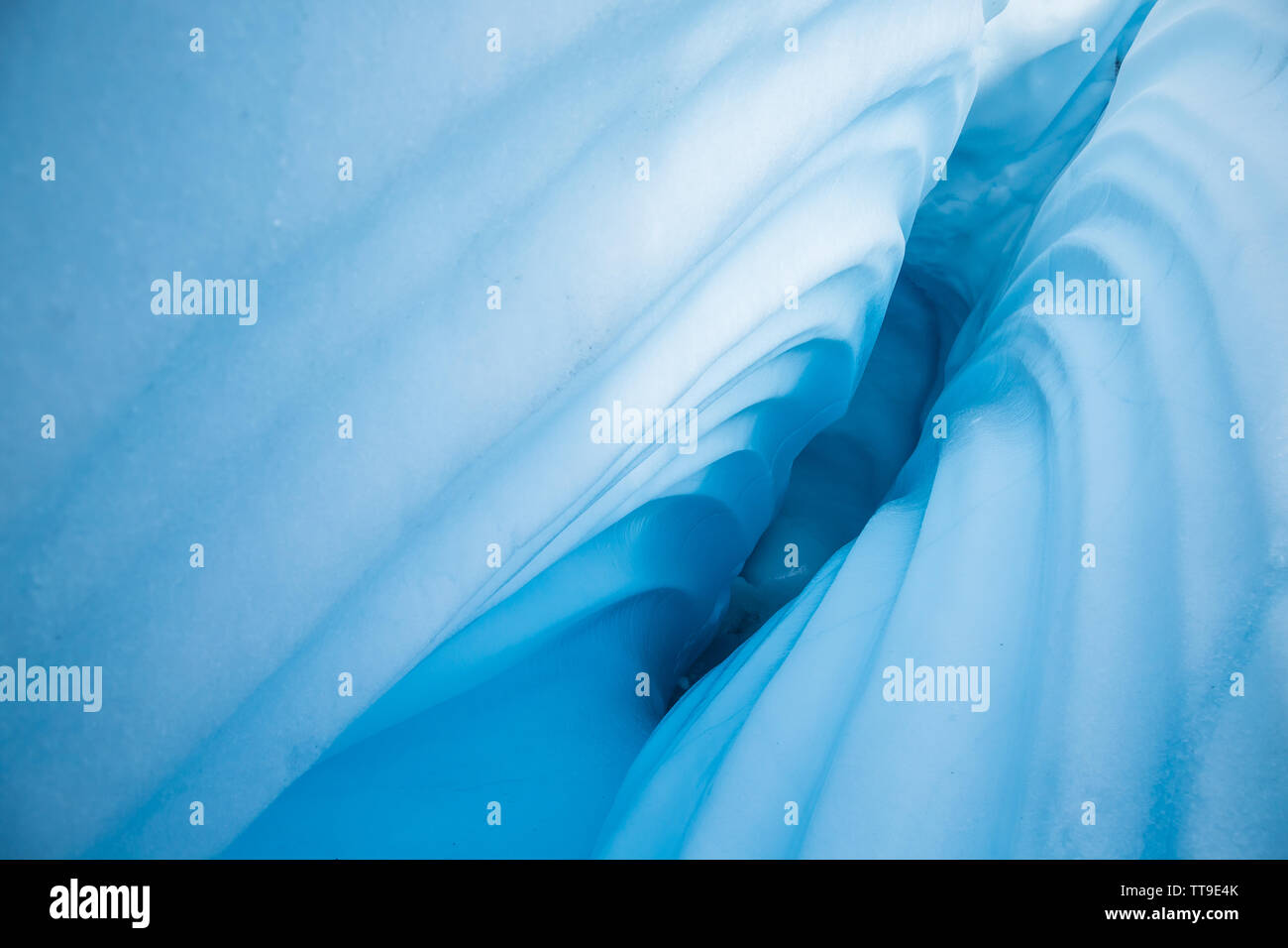 A deep crevasse on the Matanuska Glacier in Alaska. The sides have a ...