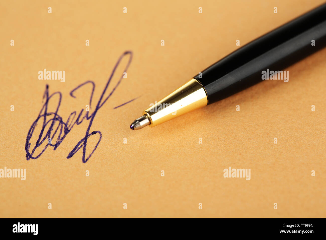 Pen and signature on paper background Stock Photo - Alamy