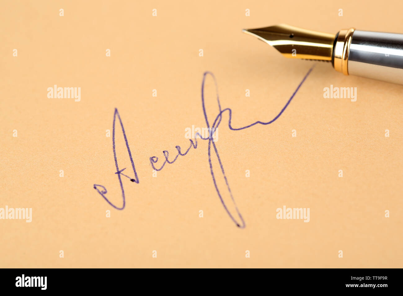 Pen and signature on paper background Stock Photo - Alamy