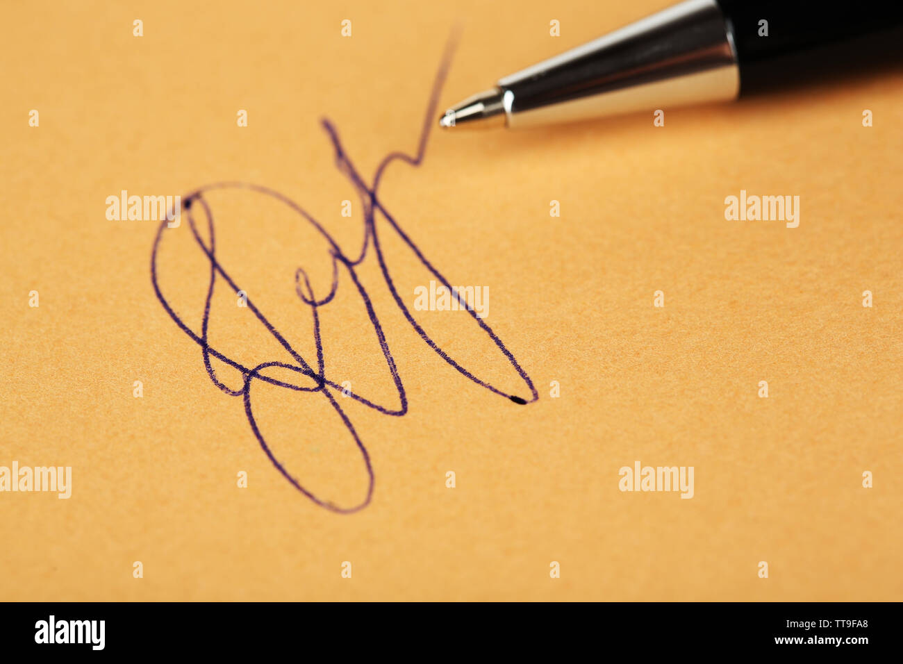 Pen and signature on paper background Stock Photo - Alamy