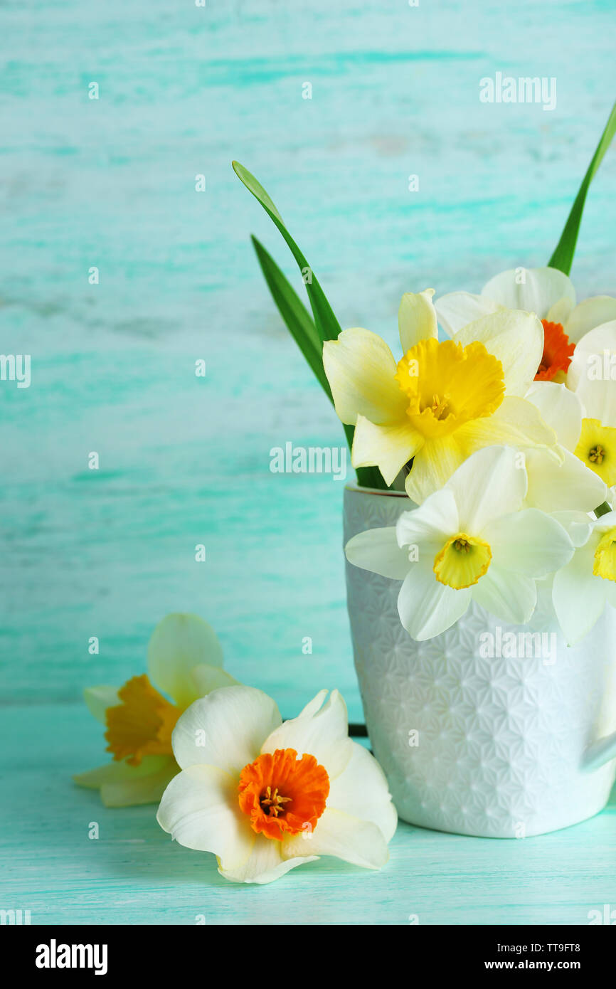 Fresh narcissus flowers on color wooden background Stock Photo - Alamy