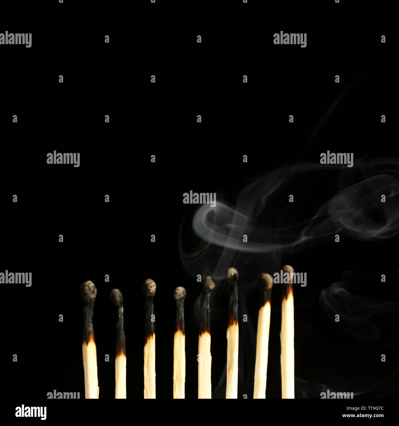 Burned matches in smoke on black background Stock Photo - Alamy