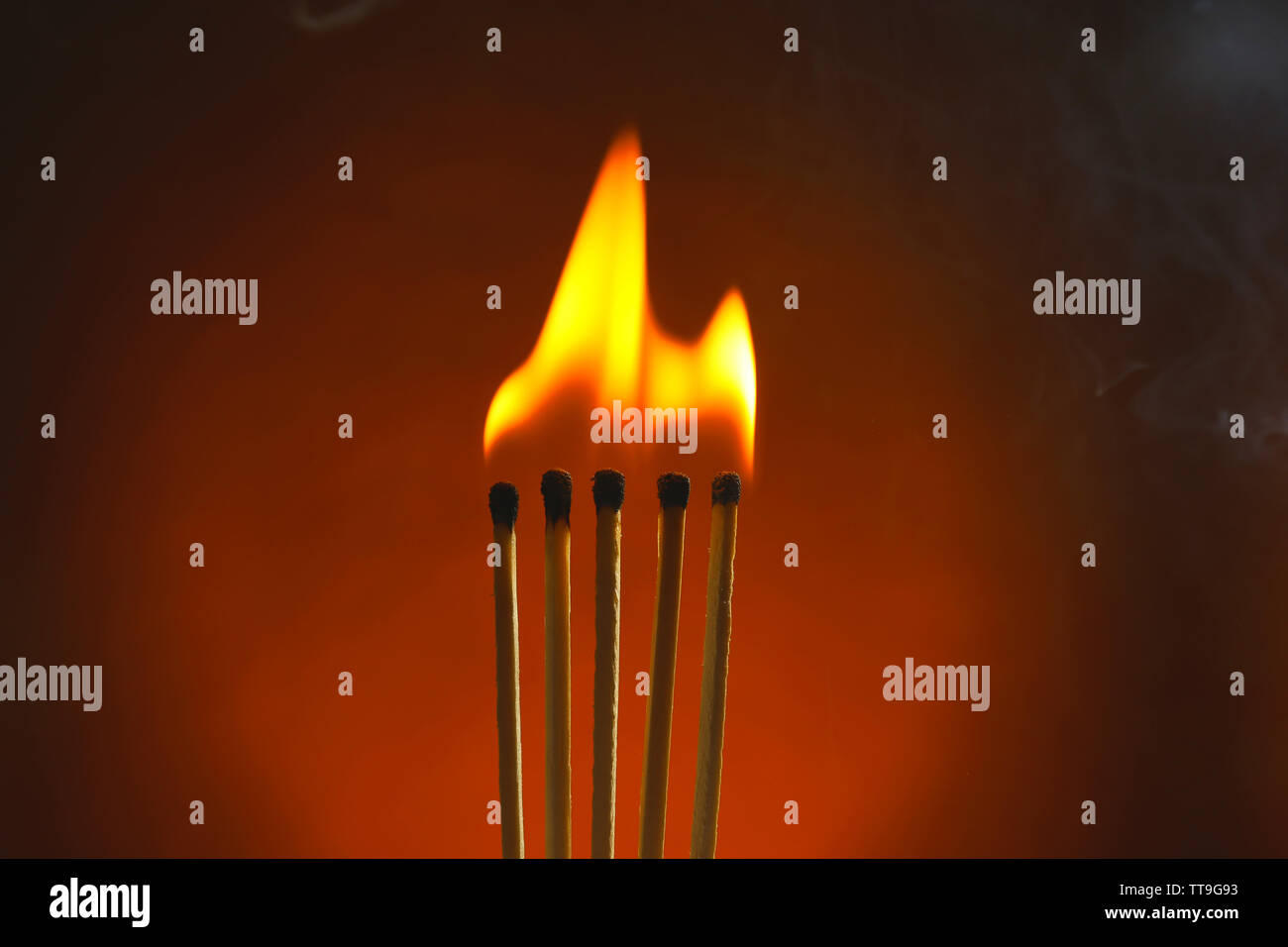Burning matches with smoke on dark color background Stock Photo - Alamy