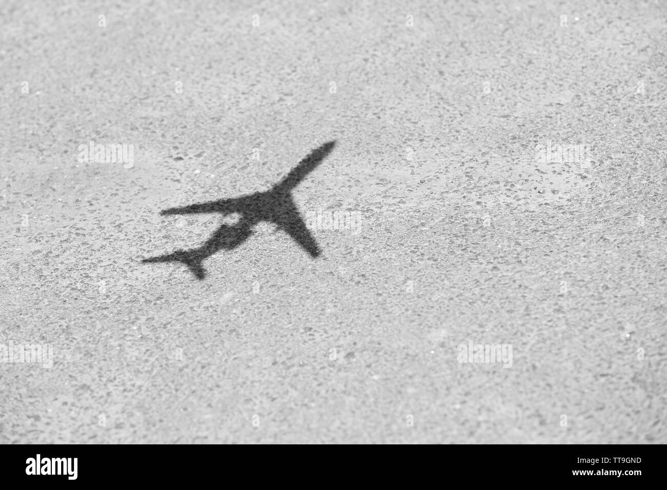 Shadow of model plane over asphalt background Stock Photo - Alamy