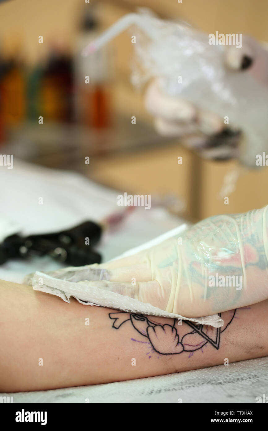 Tattoo artist at work, close-up Stock Photo - Alamy