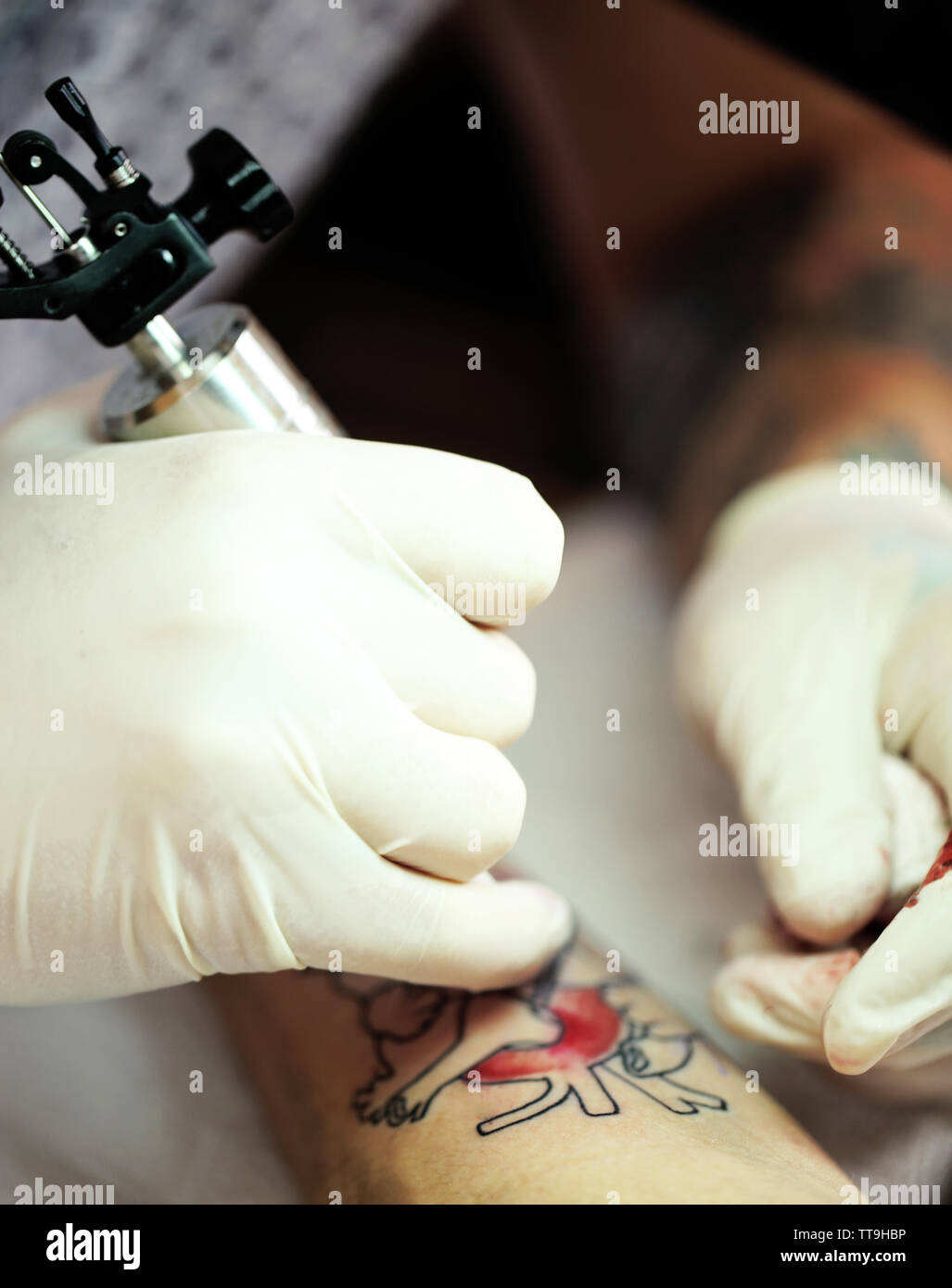 Tattoo artist at work, close-up Stock Photo - Alamy