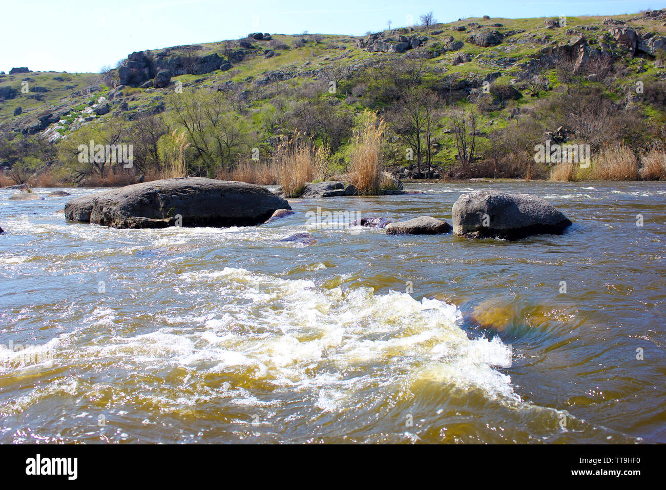Spring landscape with river, stones and trees Stock Photo - Alamy