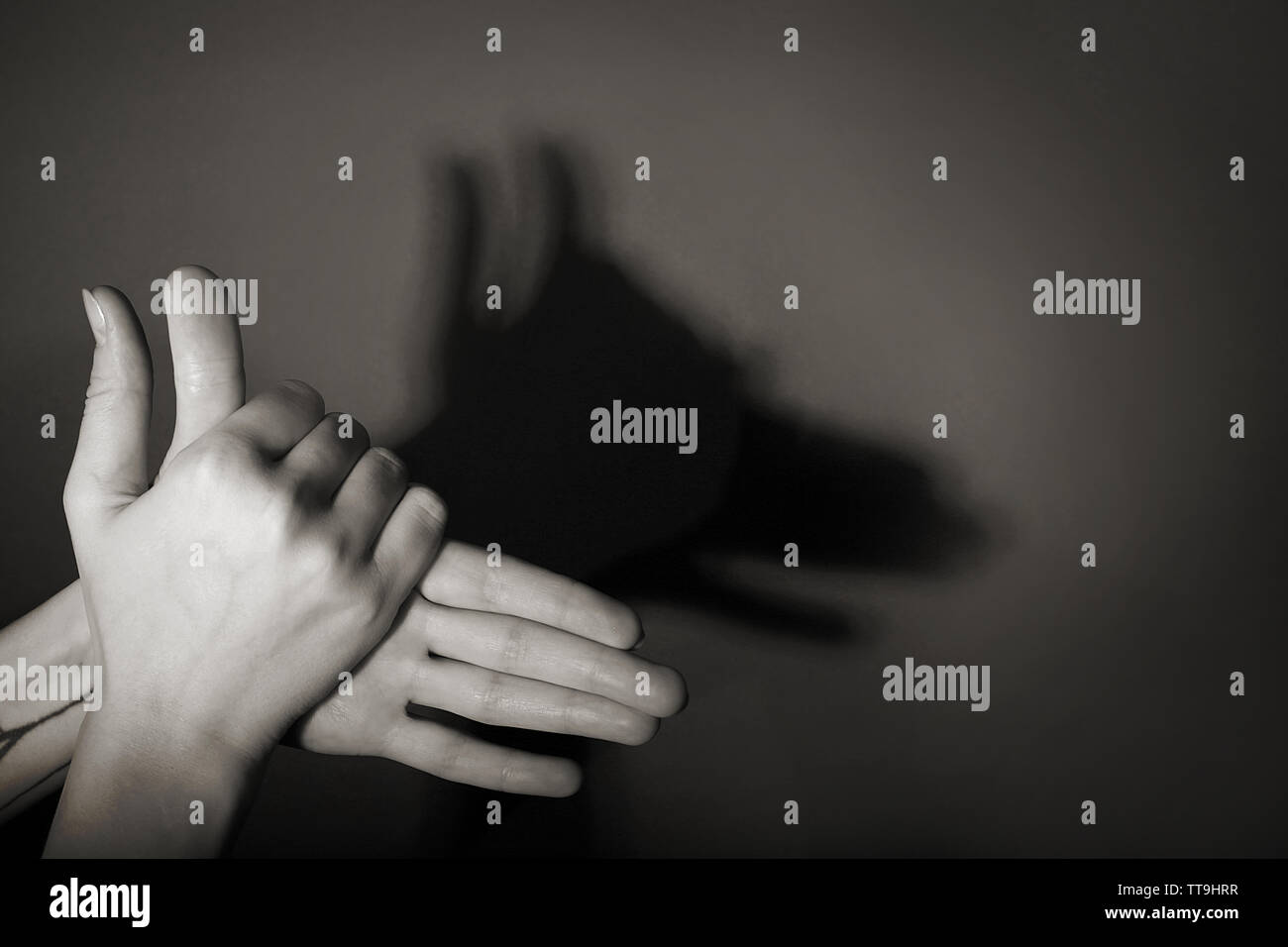 Hands gesture like dog face on gray background Stock Photo - Alamy