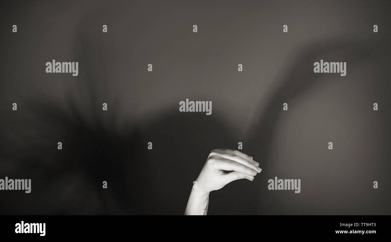 Hand gesture like ostrich on gray background Stock Photo - Alamy