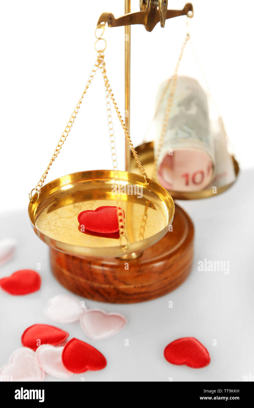 Money and heart in balance scales Stock Photo - Alamy