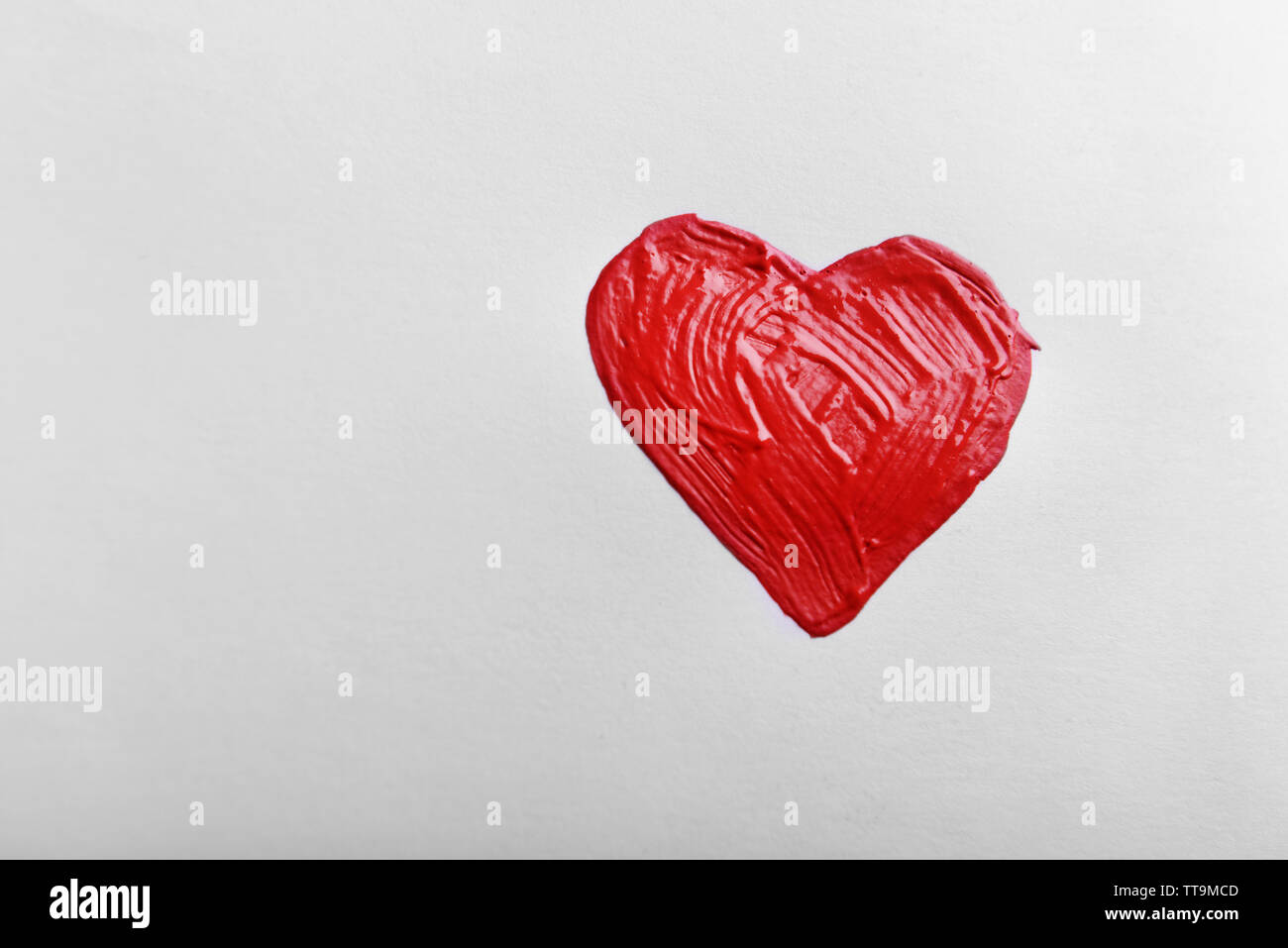 Painted red heart on white paper background Stock Photo - Alamy