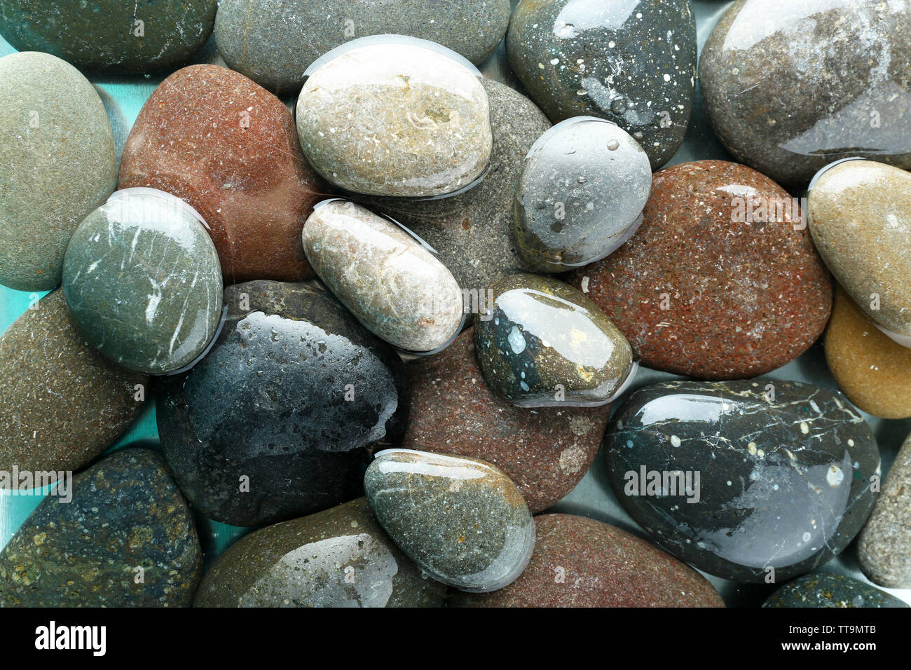 Wet sea pebbles background Stock Photo - Alamy