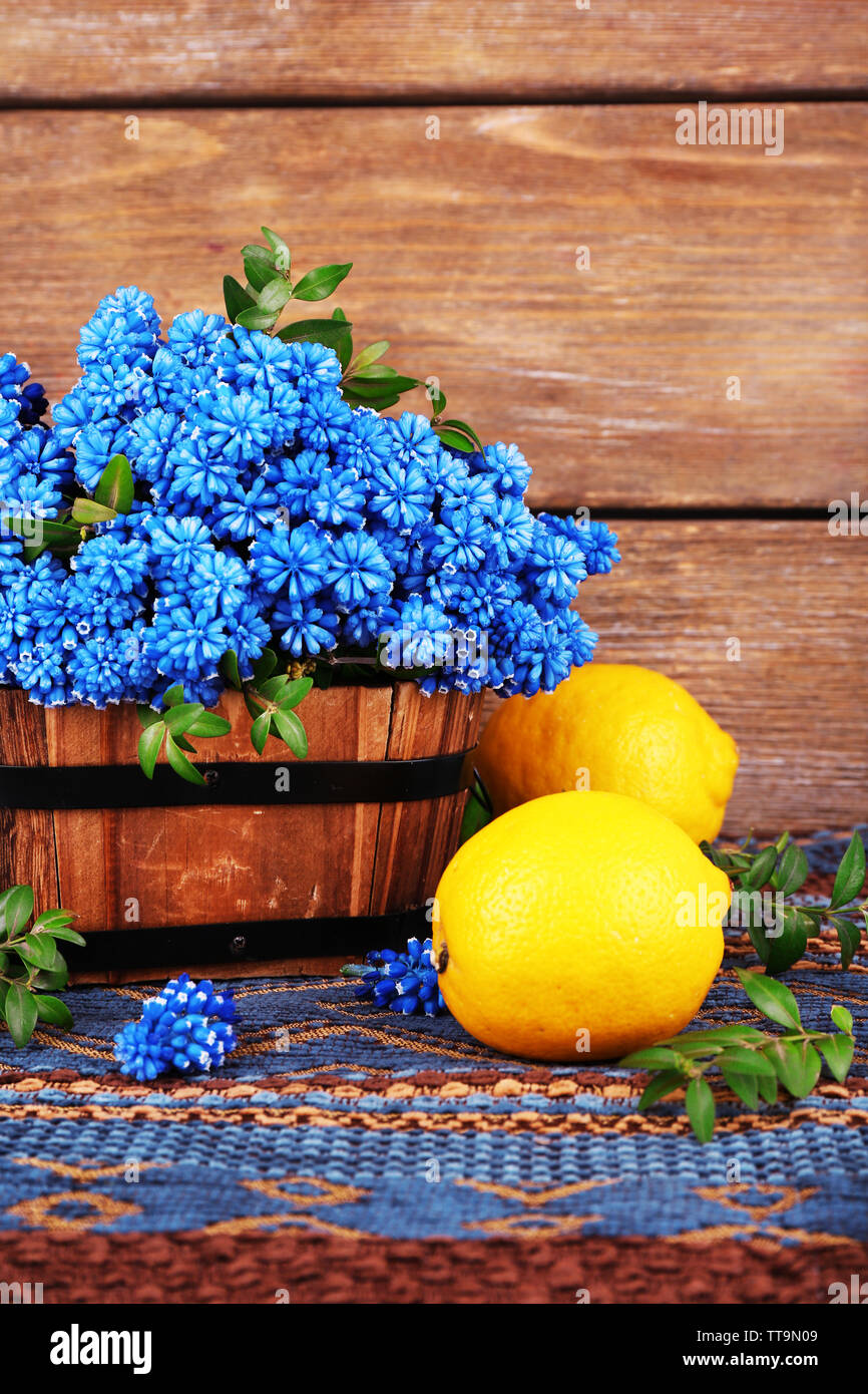 Blue bell flowers with lemon on wooden background Stock Photo - Alamy