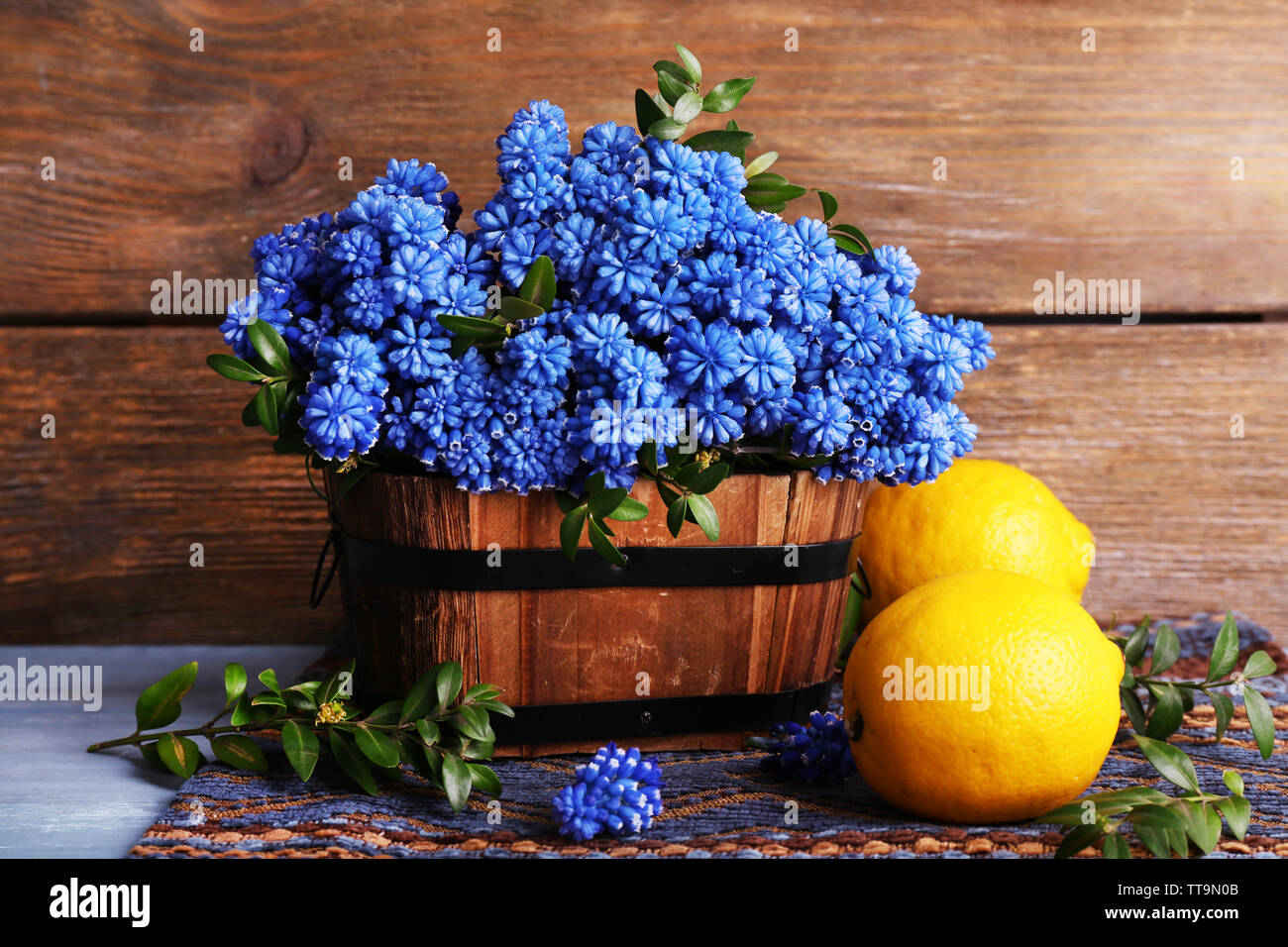 Blue bell flowers with lemon on wooden background Stock Photo - Alamy