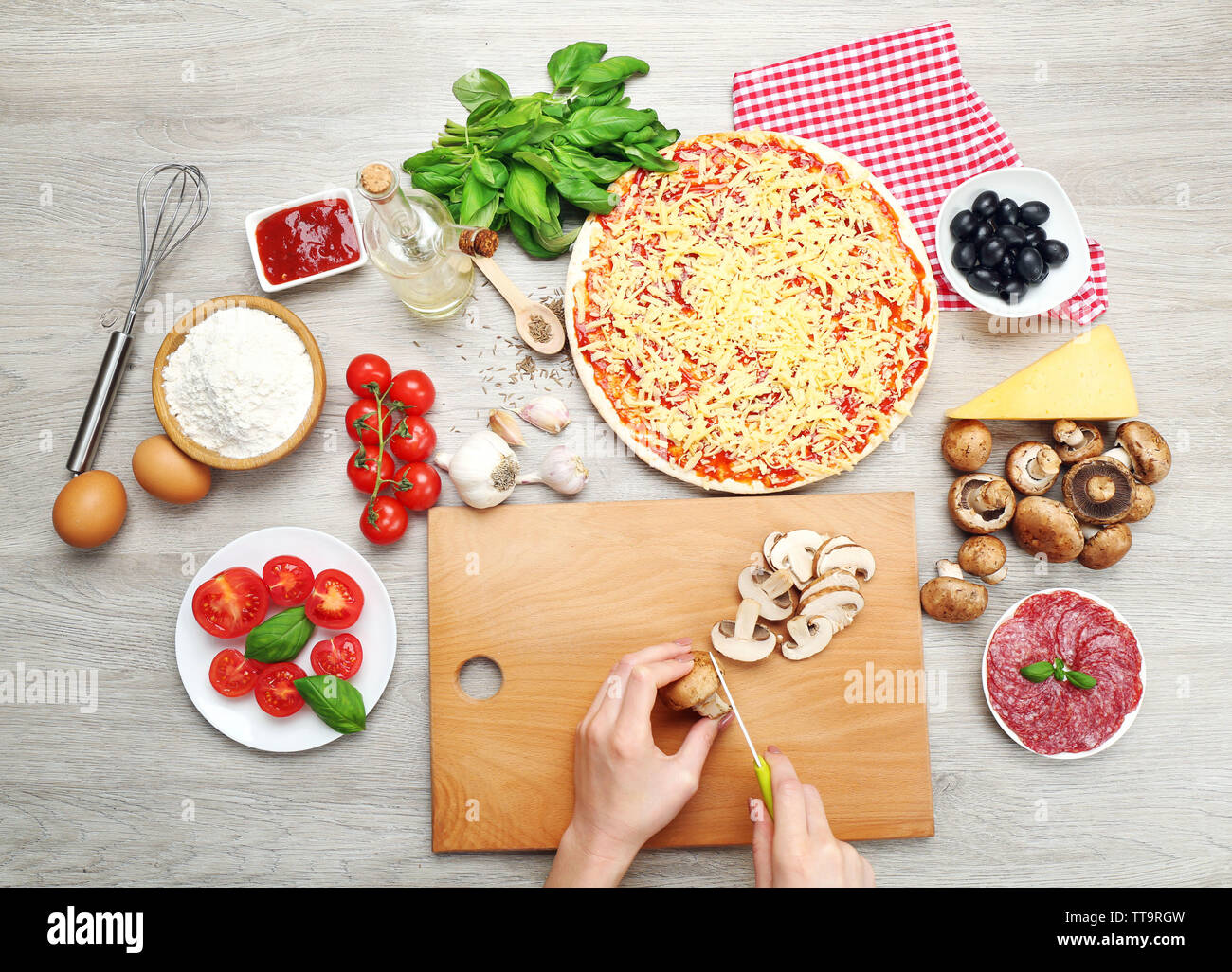 Woman making pizza on table close up Stock Photo - Alamy