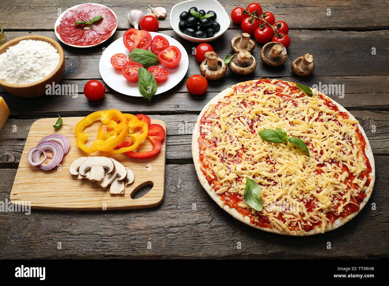 Food ingredients for pizza on table close up Stock Photo - Alamy