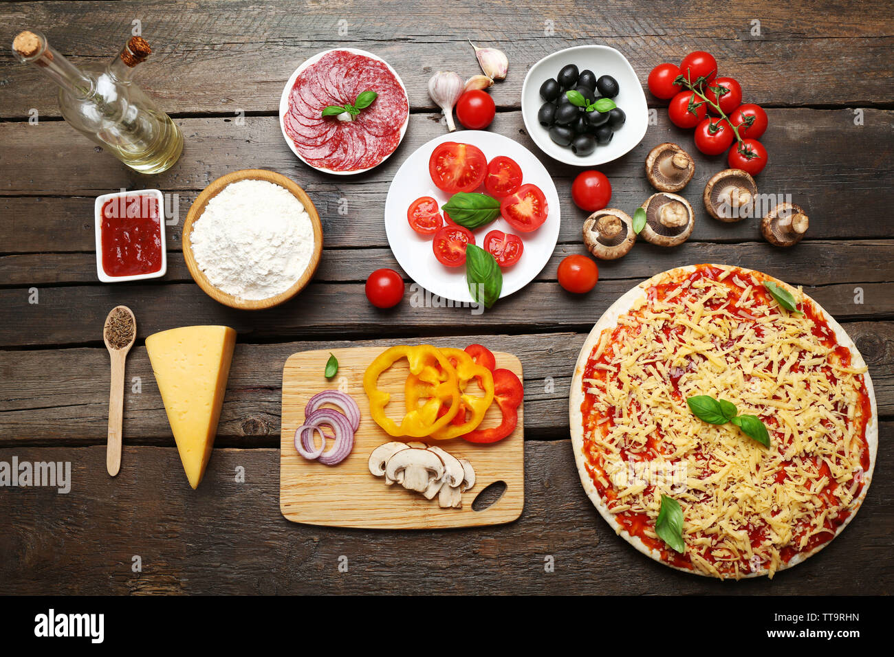 Food ingredients for pizza on table close up Stock Photo - Alamy