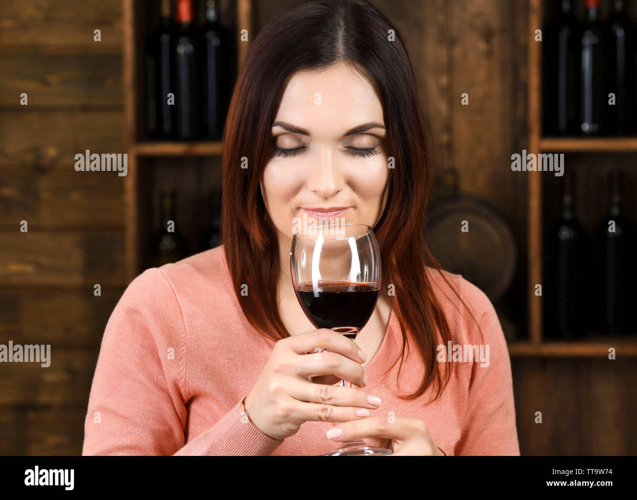 Young woman tasting wine in cellar Stock Photo - Alamy