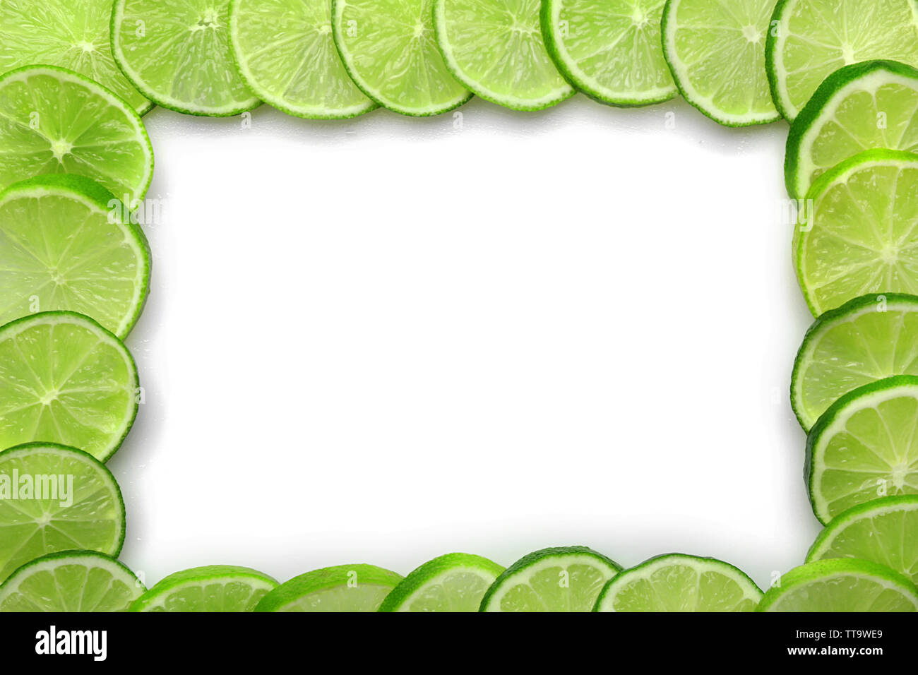 Frame of sliced fresh limes isolated on white Stock Photo - Alamy