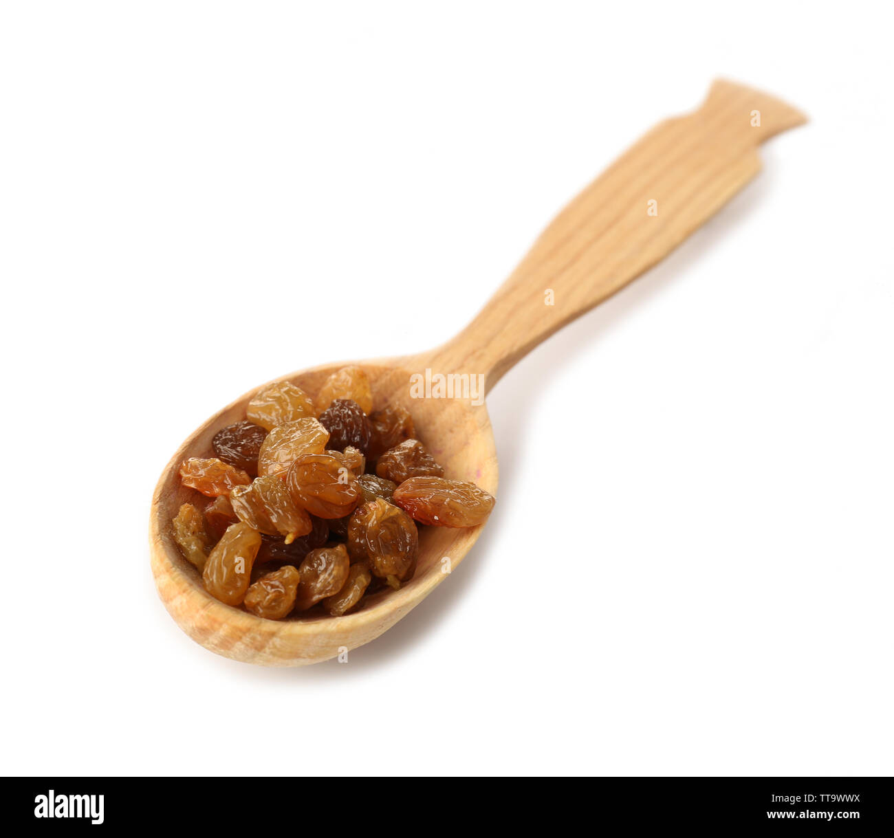 Golden raisins on wooden Cut Out Stock Images & Pictures - Alamy