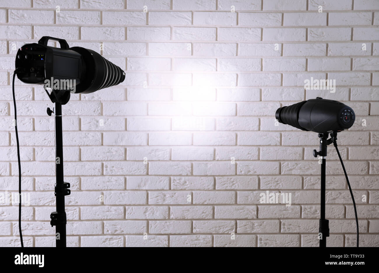 Photo studio with lighting equipment on brick wall background Stock ...