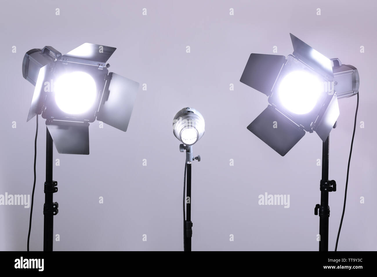 Photo studio with lighting equipment on grey wall background Stock ...