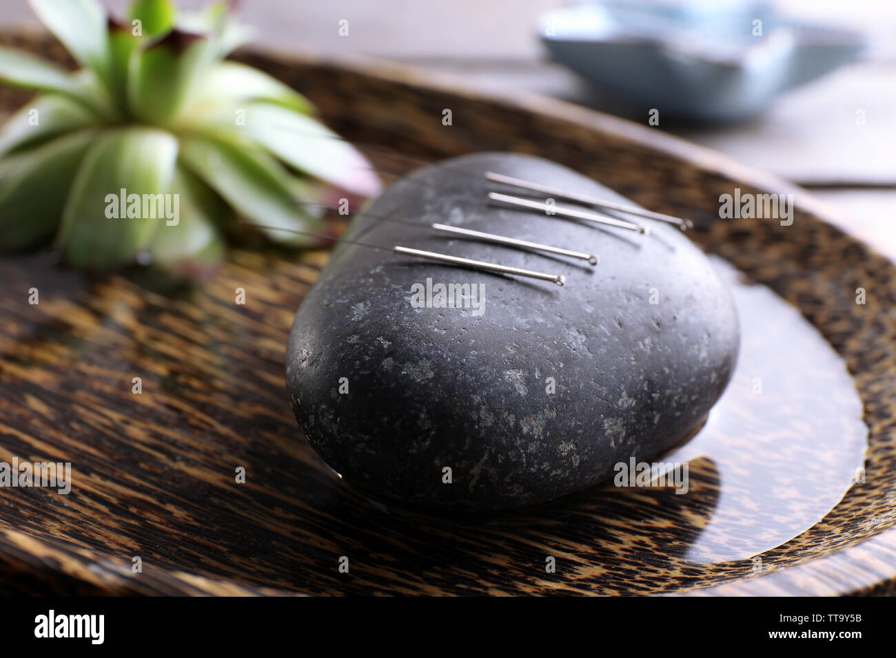 Acupuncture needle on black stone hi-res stock photography and images ...