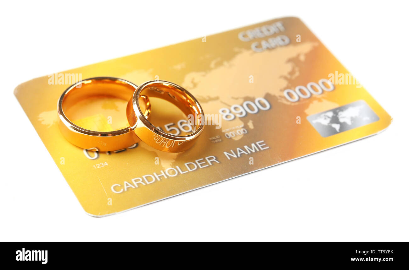 Golden wedding rings and credit card, isolated on white. Marriage of ...