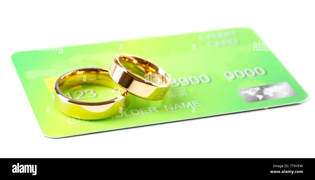Golden wedding rings and credit card, isolated on white. Marriage of ...