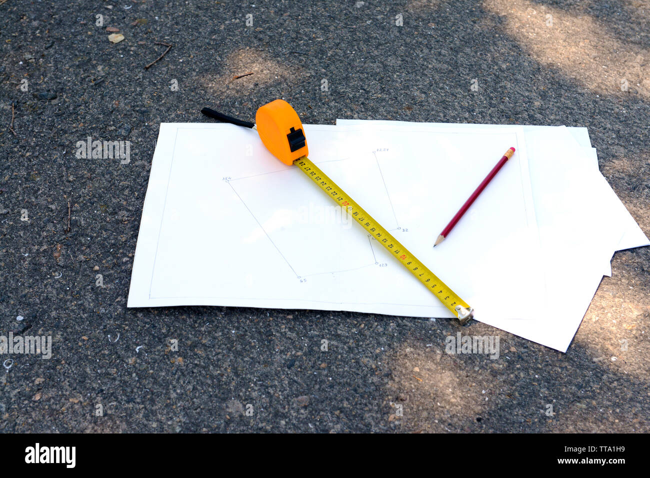 Building roulette and pencil on white sheets of paper, outdoors Stock ...
