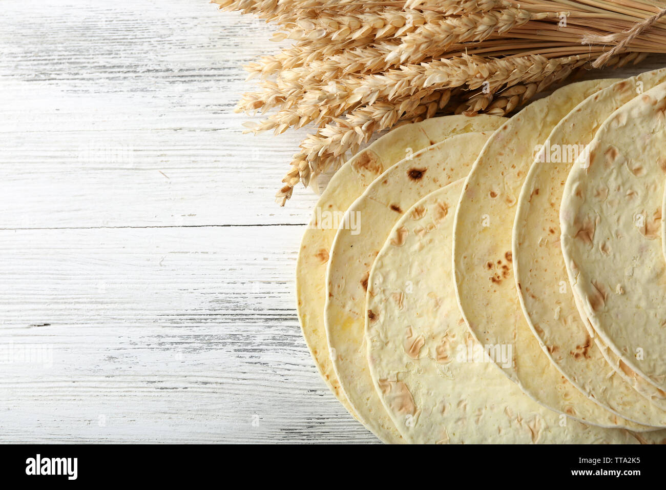 Stack of homemade whole wheat flour tortilla on wooden table background ...
