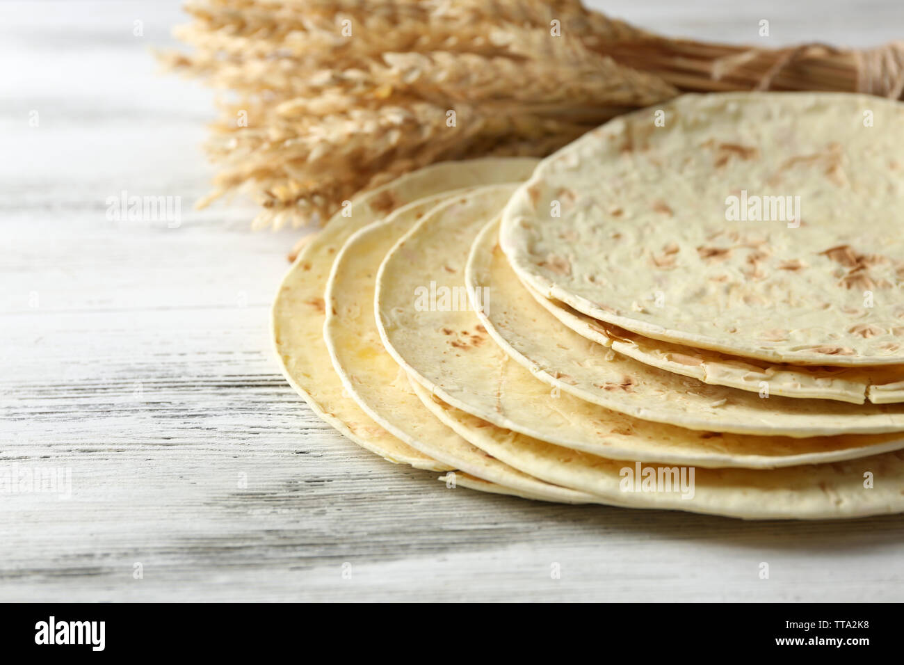 Stack of homemade whole wheat flour tortilla on wooden table background ...