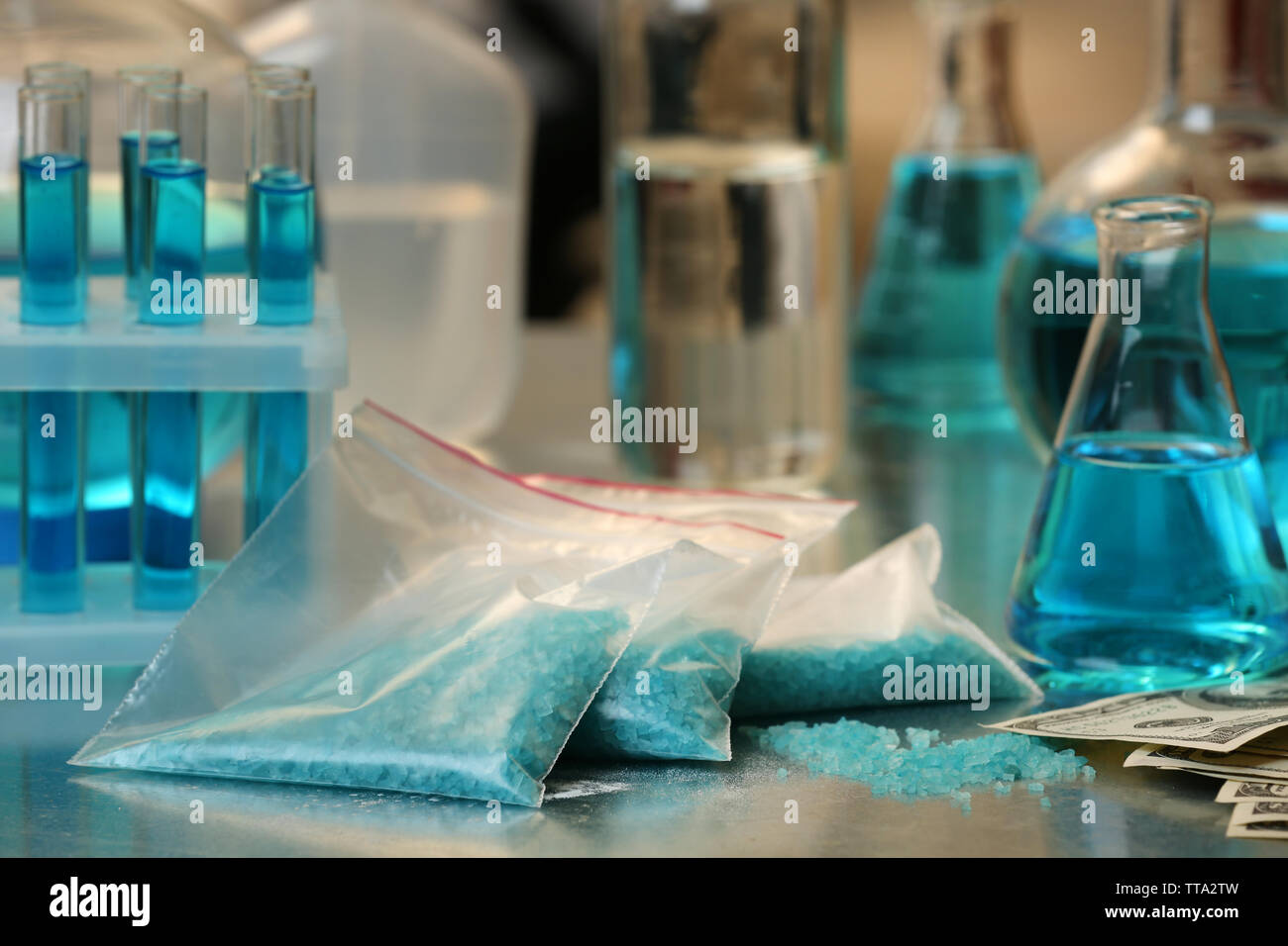 Drug laboratory: blue methamphetamine and money on table close up Stock ...