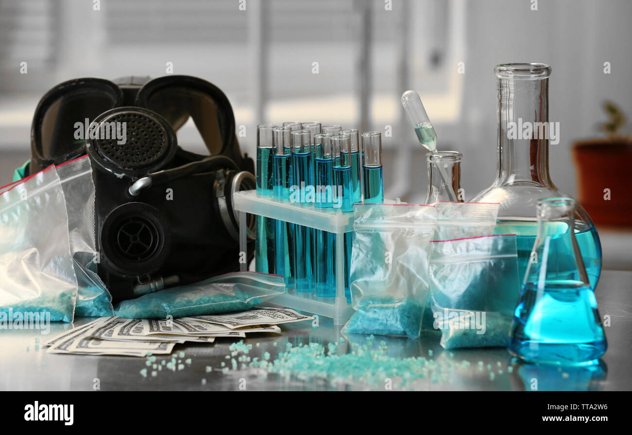 Drug laboratory: blue methamphetamine and money on table close up Stock ...