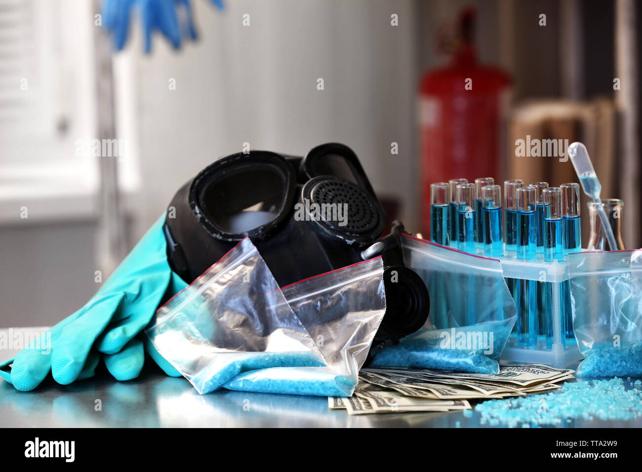 Drug laboratory: blue methamphetamine and money on table close up Stock ...