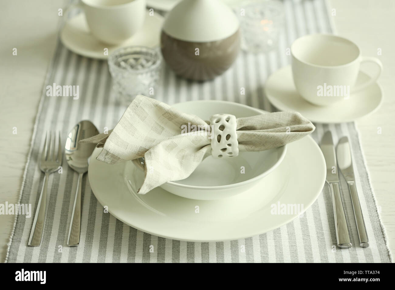 Beautiful holiday table setting in white and gray color Stock Photo - Alamy