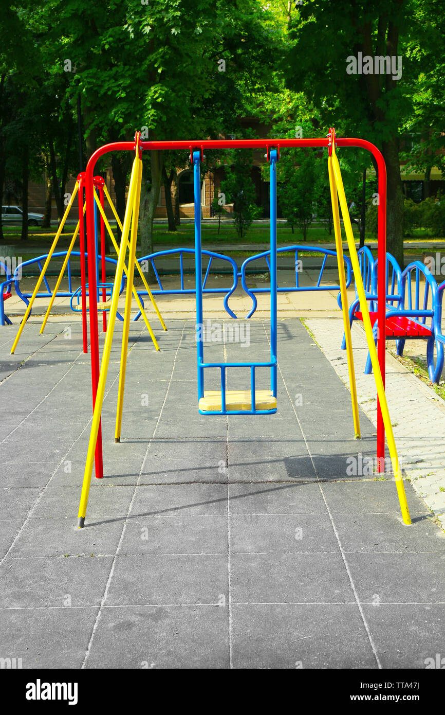 Empty chain swings on playground in public park Stock Photo - Alamy
