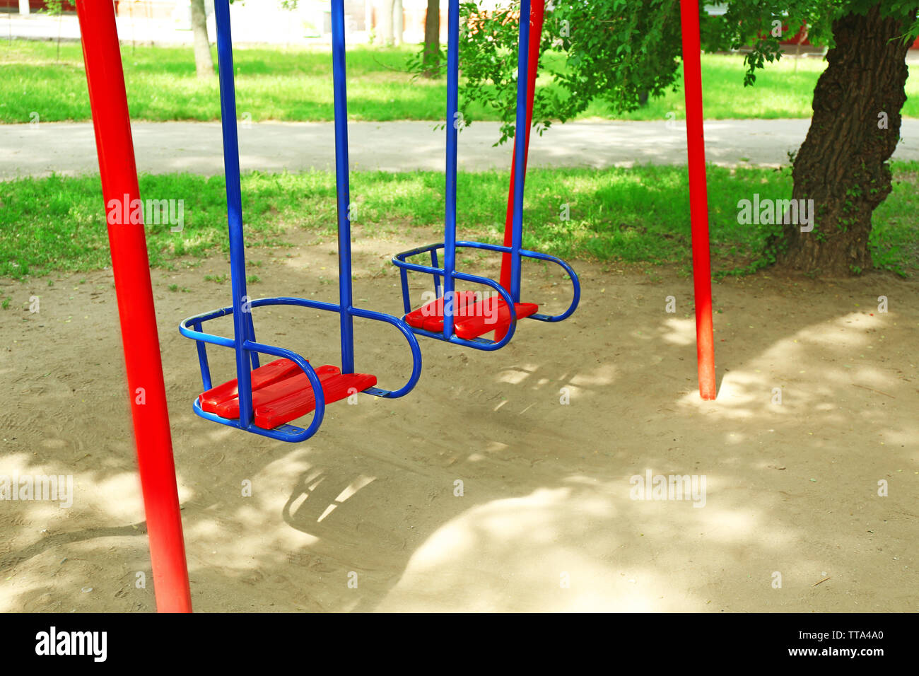 Empty chain swings on playground in yard Stock Photo - Alamy