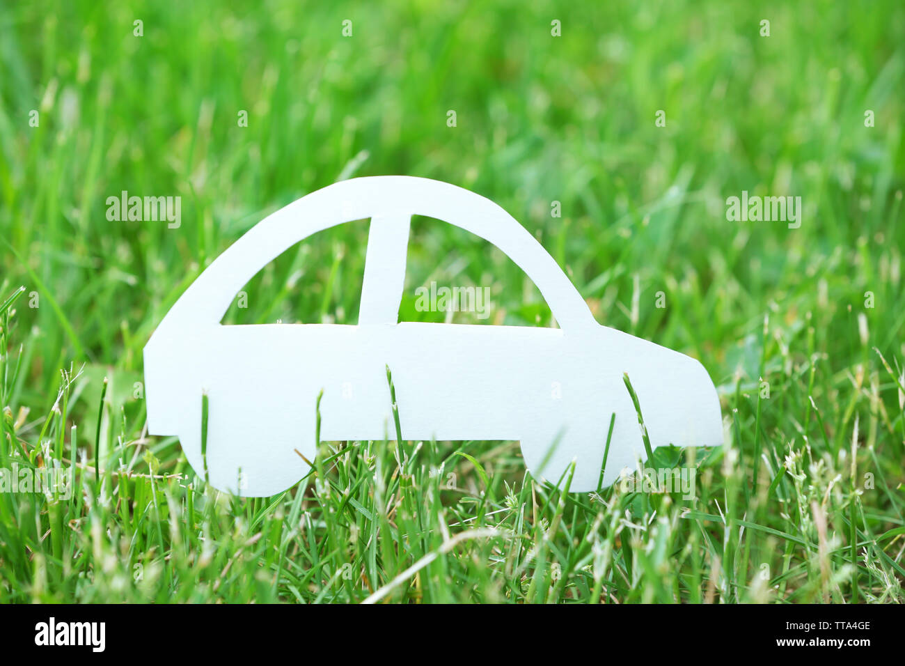 Cutout paper car over green grass background Stock Photo - Alamy