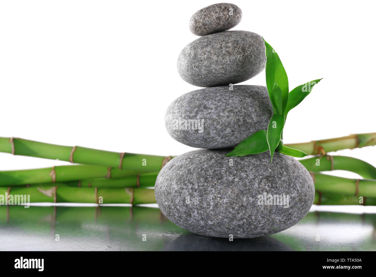 Stack of spa stones with bamboo sticks isolated on white Stock Photo ...