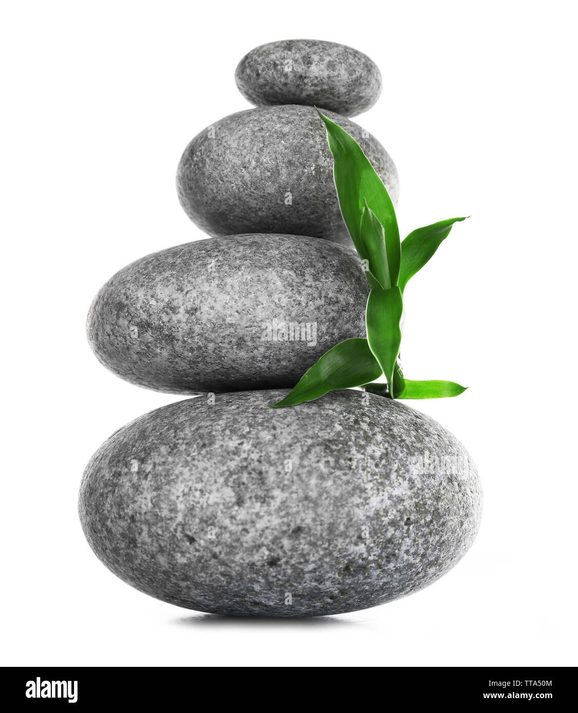 Stack of spa stones with green leaves isolated on white Stock Photo - Alamy