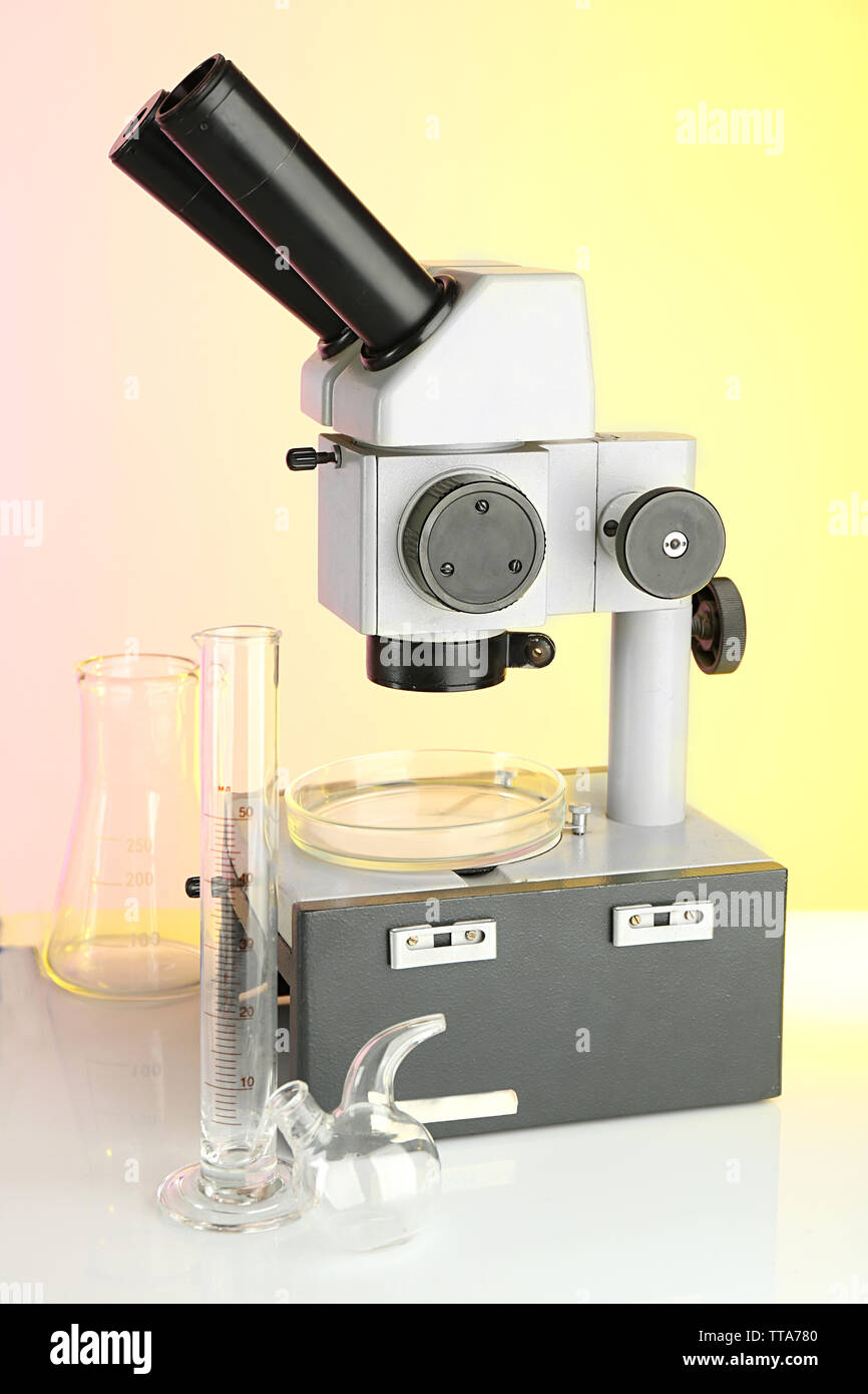 Test tubes and microscope on bright background Stock Photo - Alamy