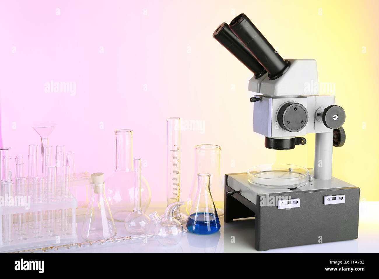 Test tubes and microscope on bright background Stock Photo - Alamy