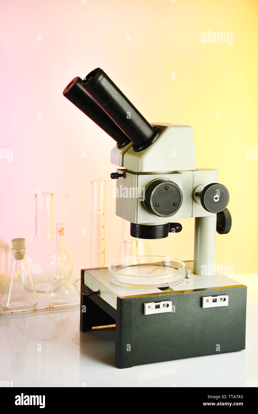 Test tubes and microscope on bright background Stock Photo - Alamy